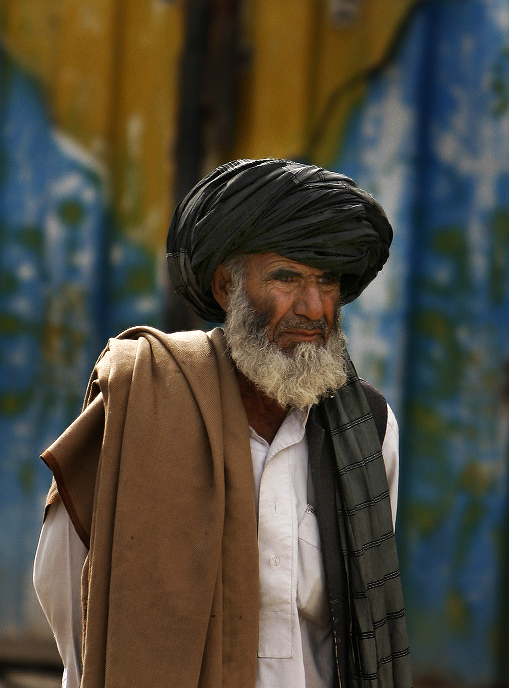 An Afghan man wears a dark turban and two scarves, Feb. 9, 2009.