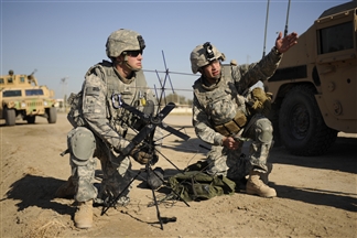 Sgt. Ryan Pike and Staff Sgt. Altaf Swati set up a tactical satellite ...