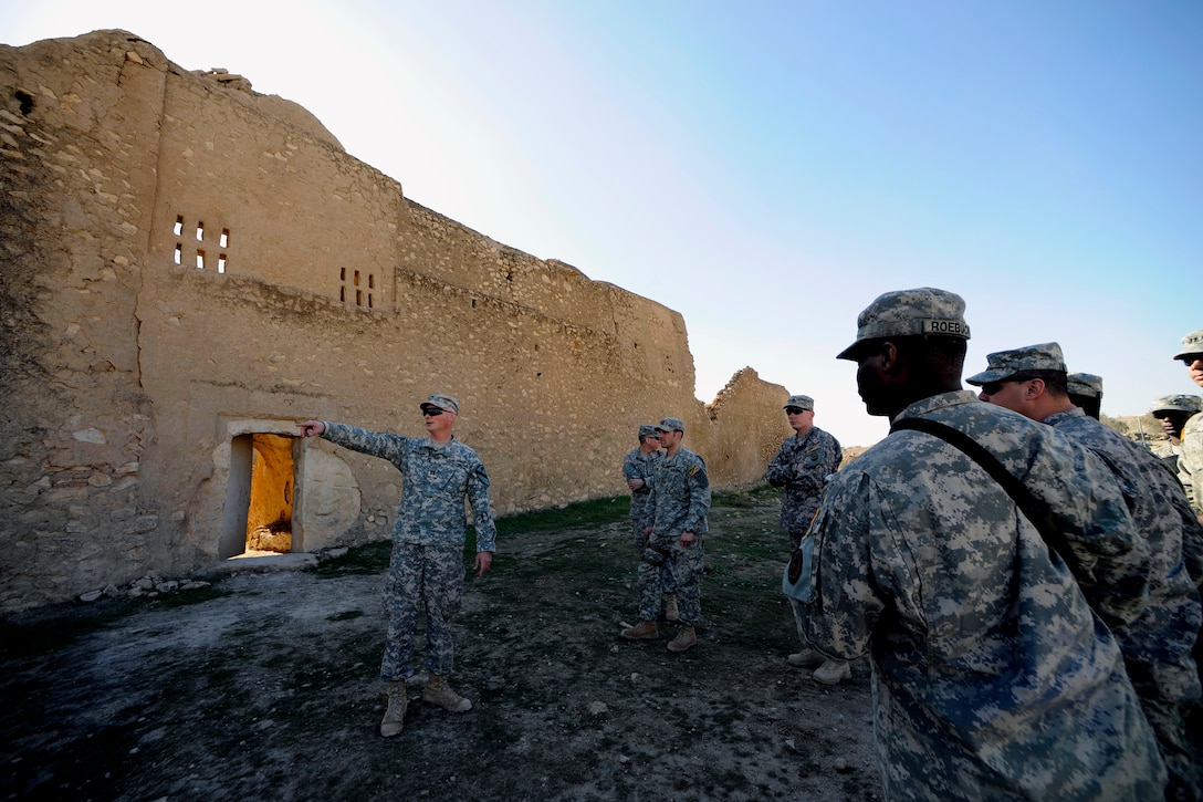 U.S. Army Capt. Rick Brunson, chaplain, left, gives soldiers a tour of ...