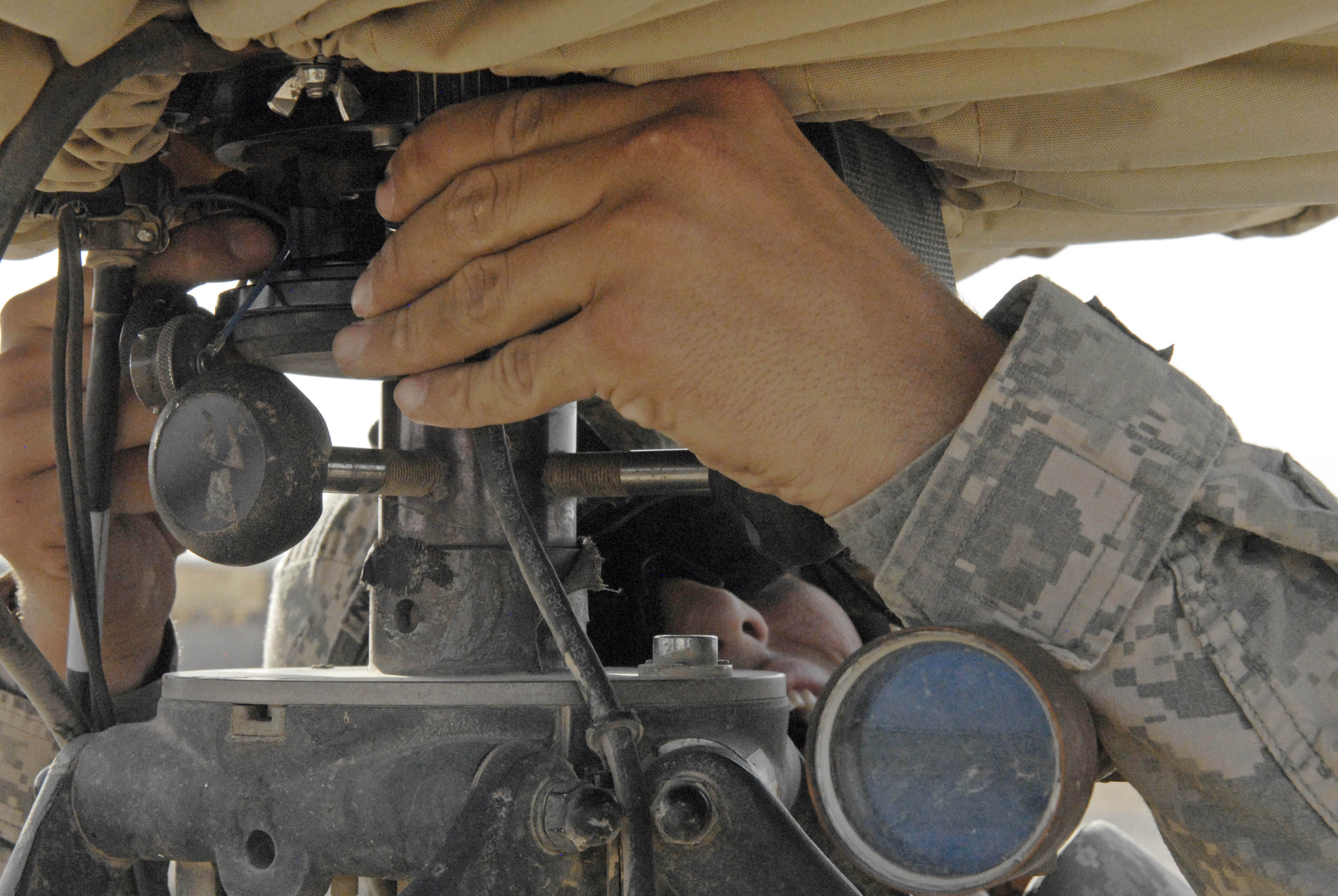 Army Pfc. Dustin Clark adjusts the sights on a radar system at ...