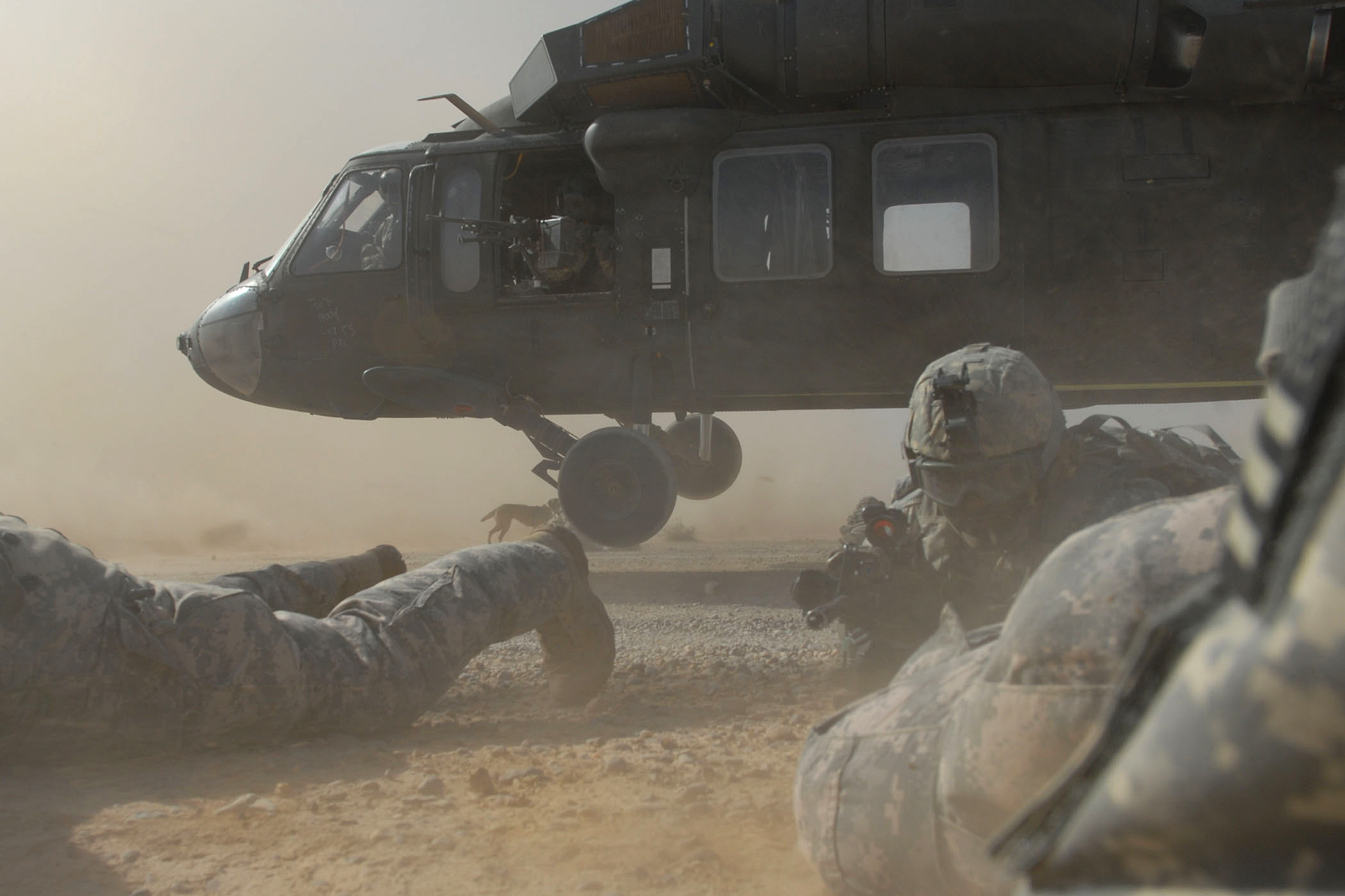 U.S. Army Staff Sgt. Craig Stevens, center, maneuvers through a cloud ...