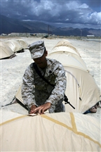 Corpsman David Ropp prepares his equipment. | U.S. Department of War