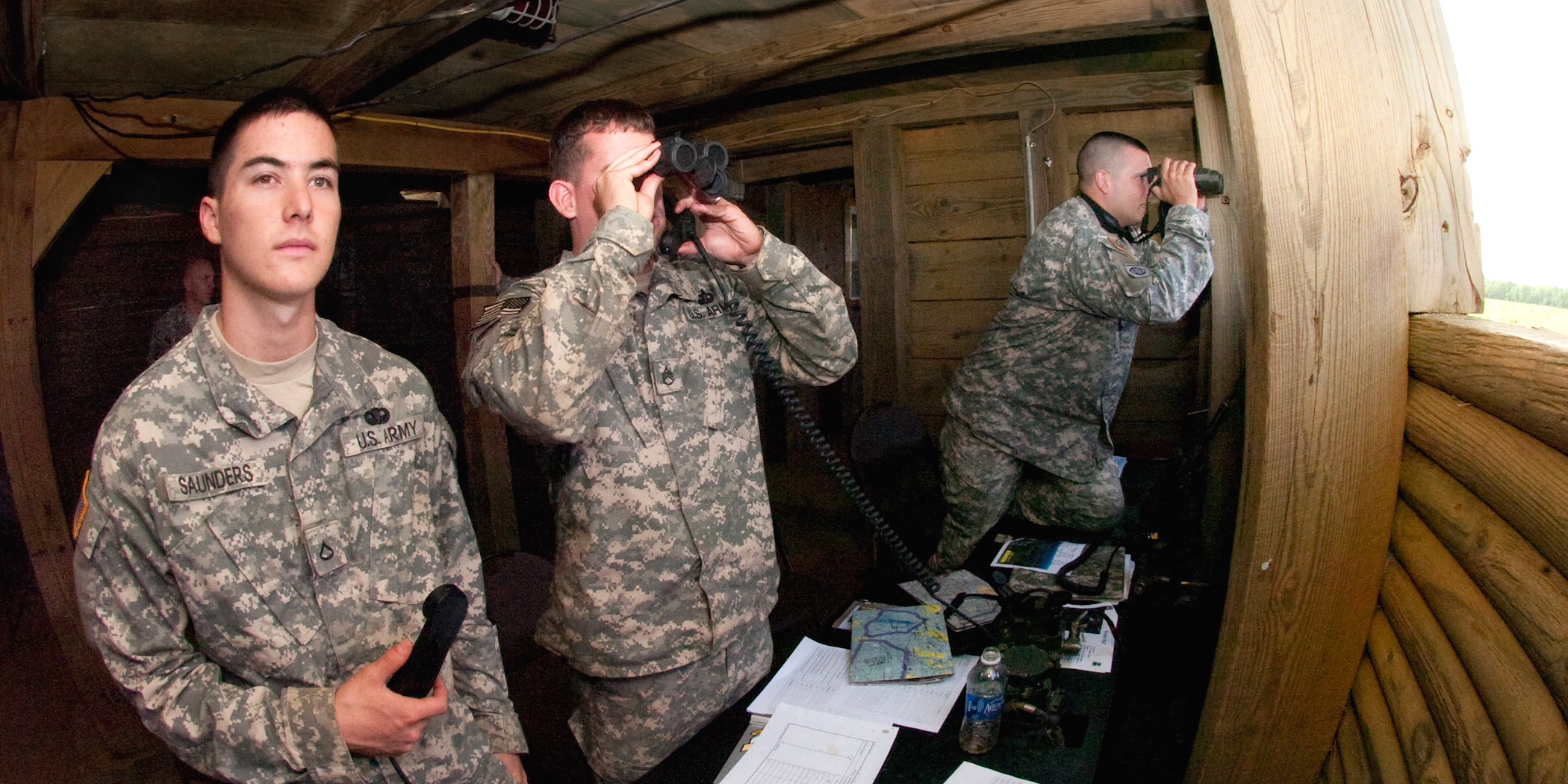 Inside an earthen bunker, U.S. Army Pvt. 1st Class Ryan Saunders, left ...