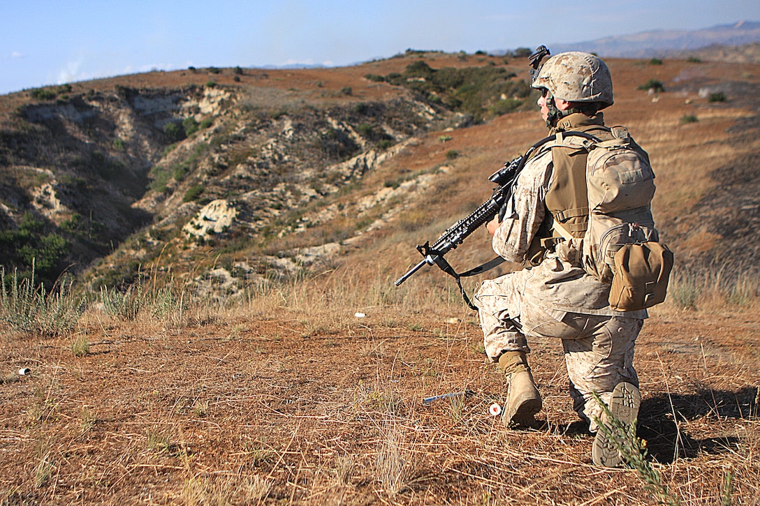 U.S. Marine Corps Lance Cpl. Adam M. Hallett provides security during a ...