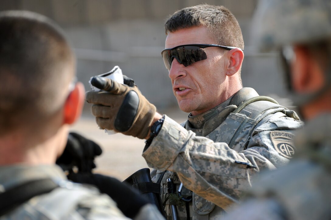 U.S. Army Sgt. Daniel Cooper passes information to his soldiers after ...
