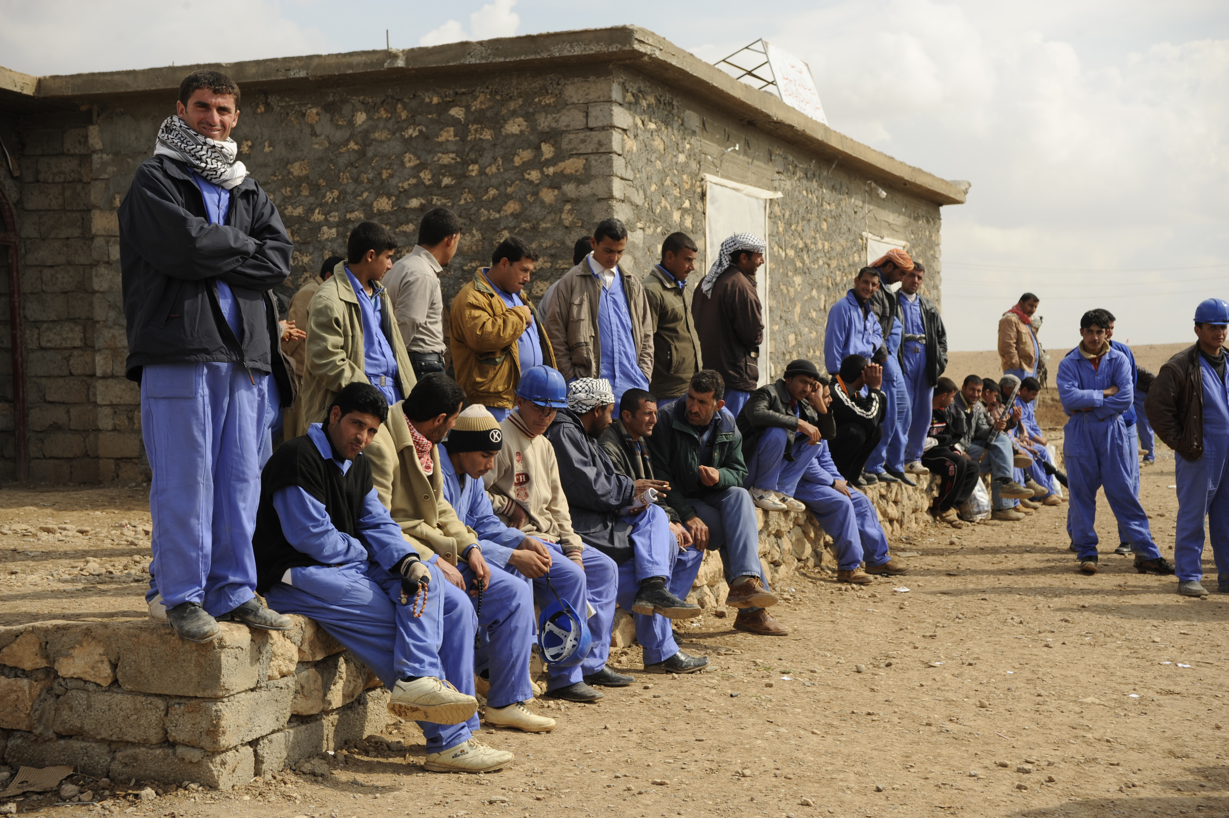 Iraqi men take a break from a class at a Civil Service Corps site in ...