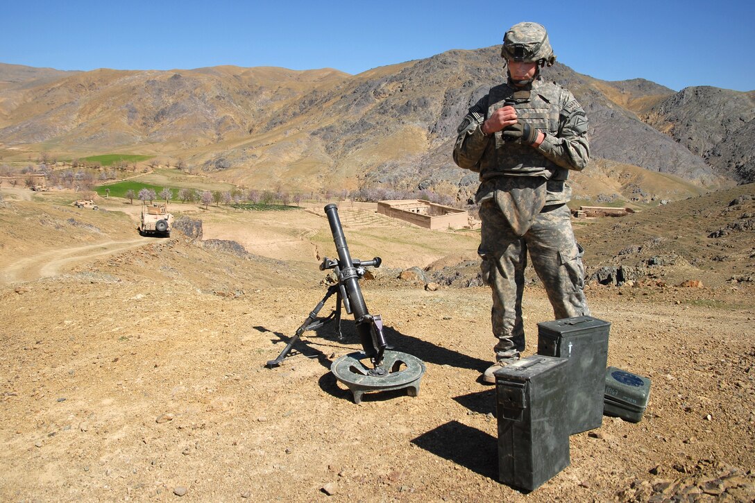 U.S. Army Spec. Stephen Highberger sets up his 60mm mortar system on a ...
