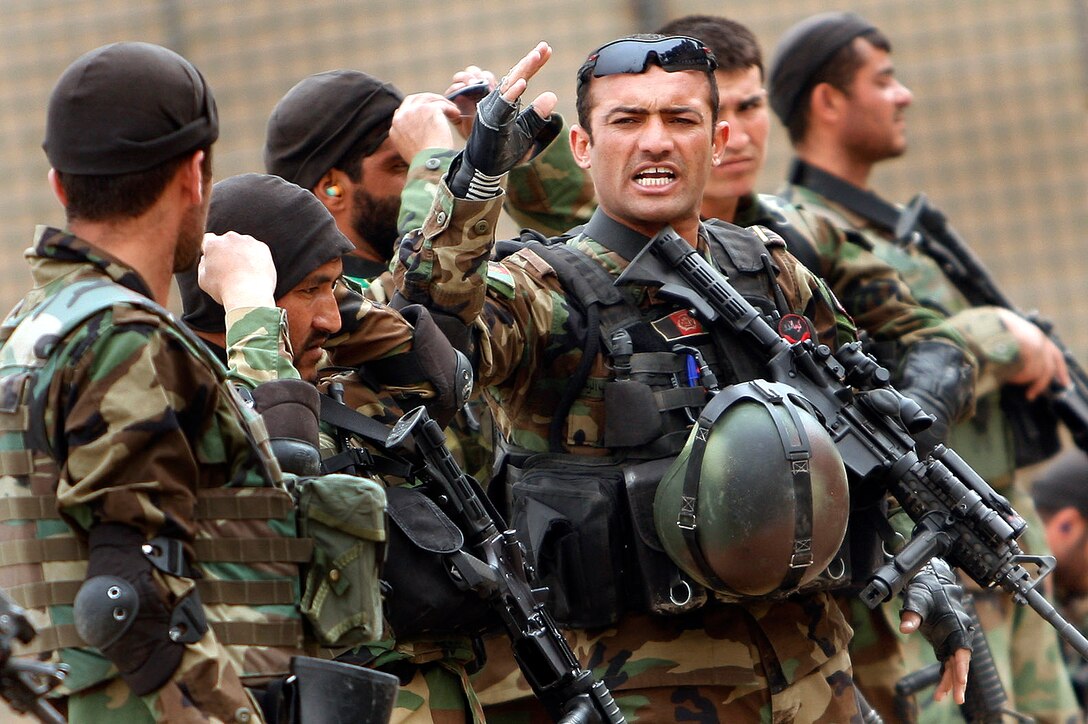 An Afghan National Army Commando issues orders to his team during a ...