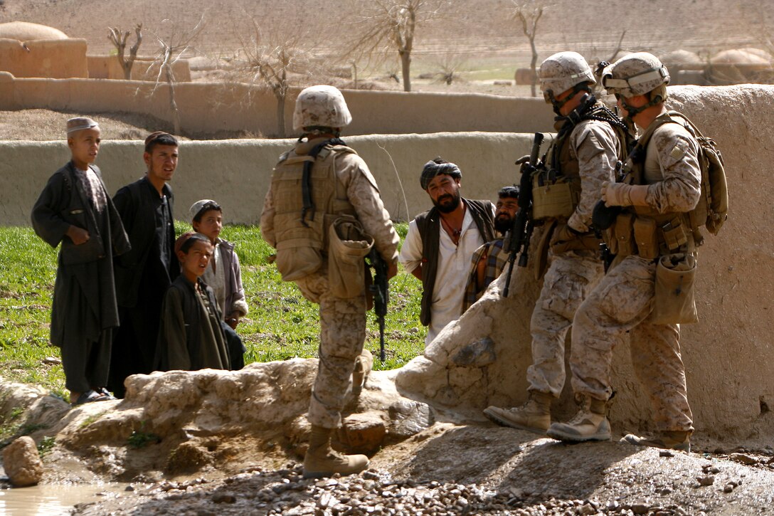 U.S. Marine Corps Capt. Anthony R. Ward, center, speaks with Afghans ...
