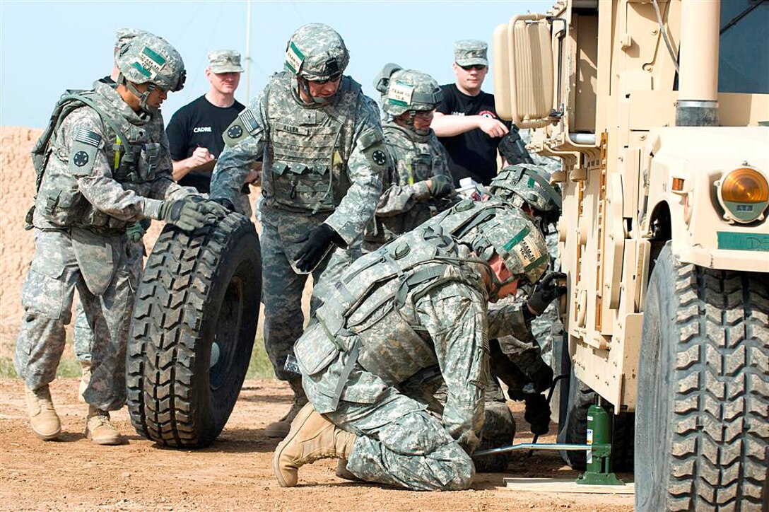 U.S. Army soldiers compete for time in the Humvee tire-change event ...