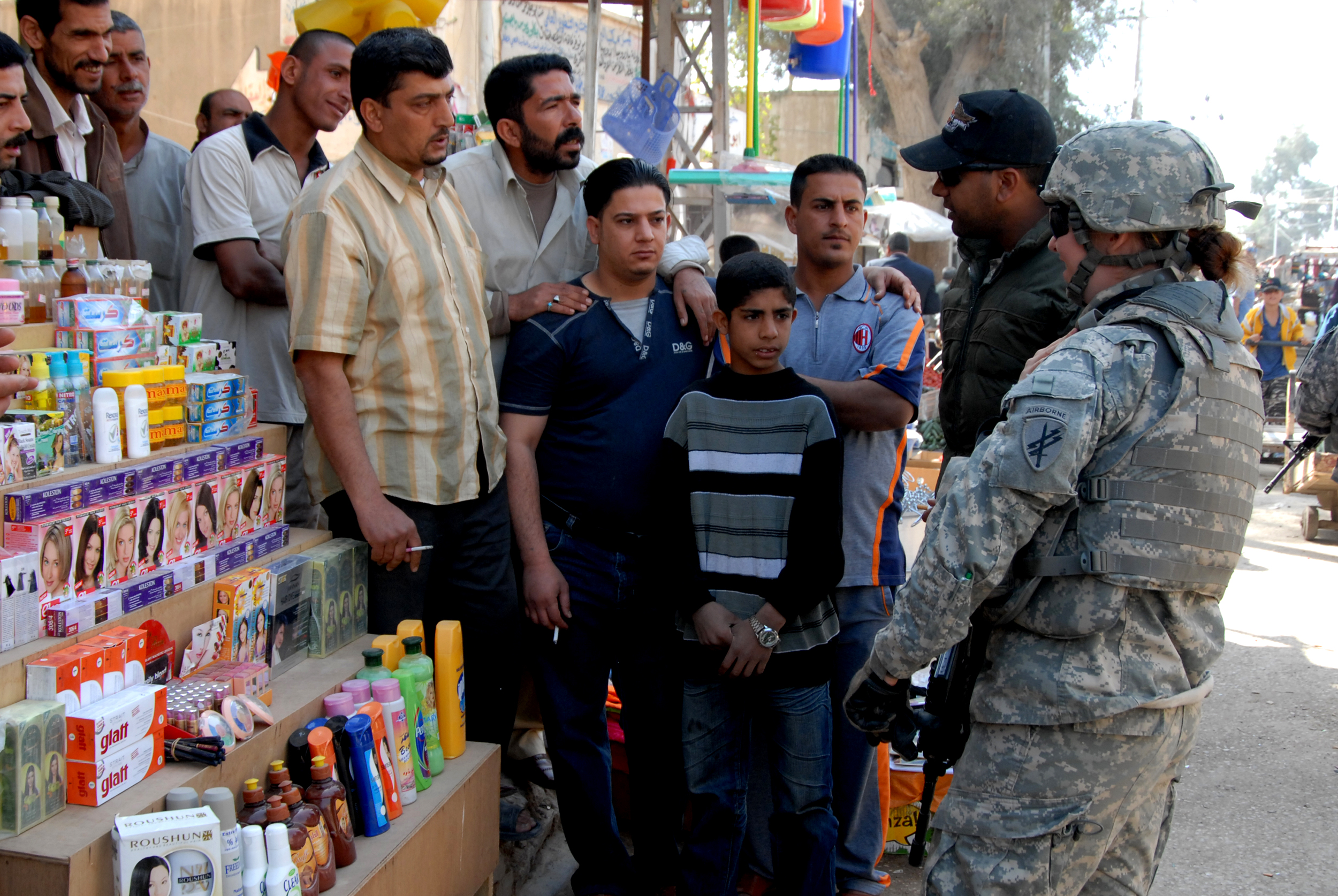U.S. Army Spc. Laura Garretto talks with Iraqi vendors and citizens at ...