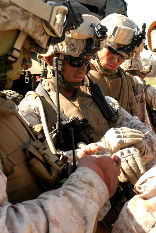 U.S. Marine Corps Cpl. Quentin Hamilton, left, Sgt. Galen Scott, center ...