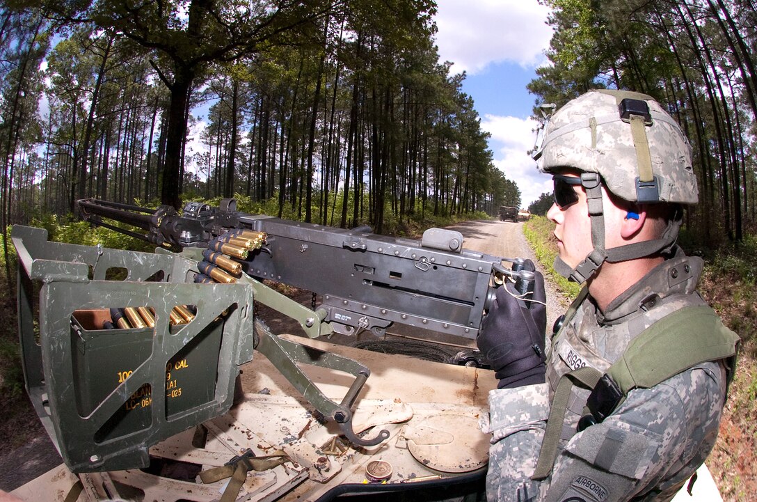 U.S. Army Pvt. 1st Class Andrew T. Dickson mans a .50-caliber machine ...
