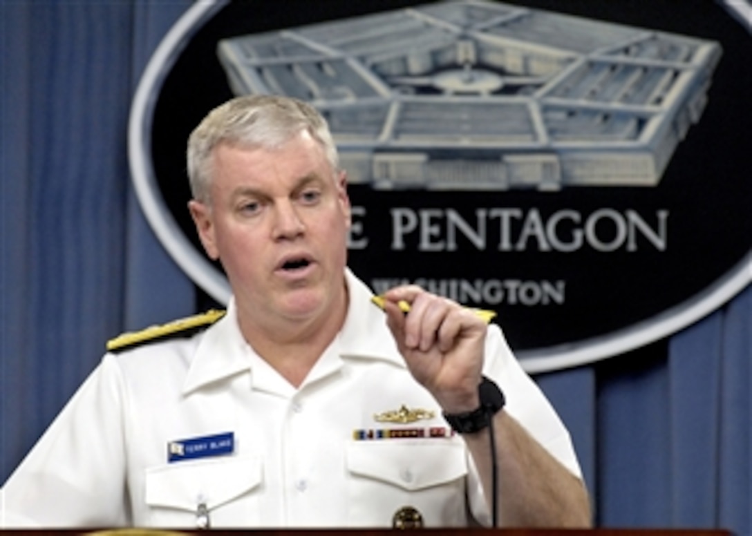Rear Adm. Terry Blake conducts a press briefing.