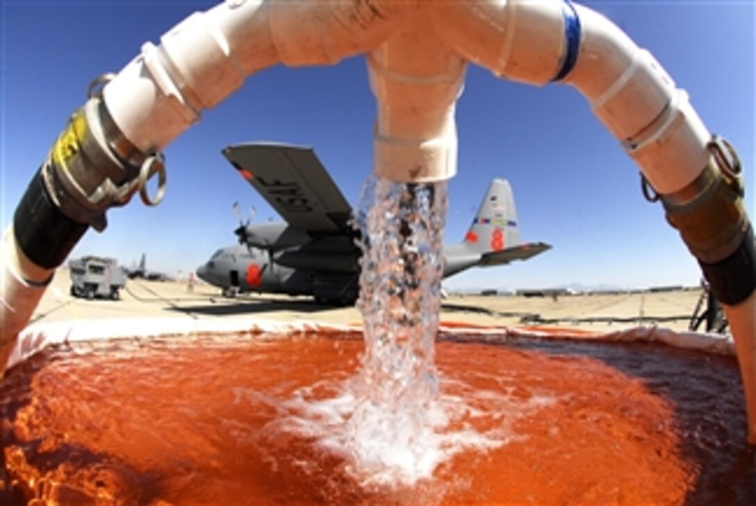 Water flows into a container prior to U.S. Air Force airmen ...