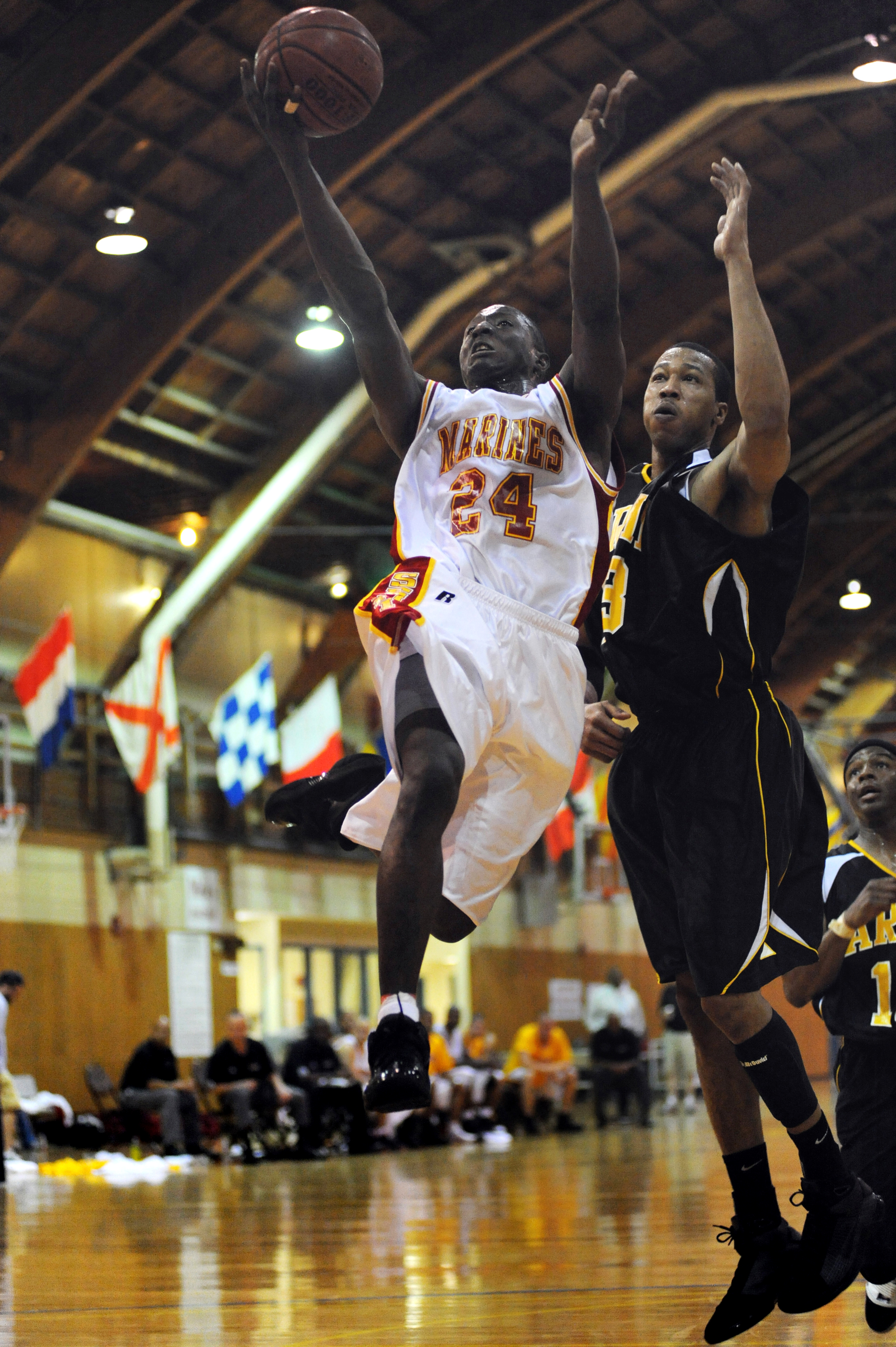 All Marine Staff Sgt. Willie Nathan drives the ball to the basket for ...