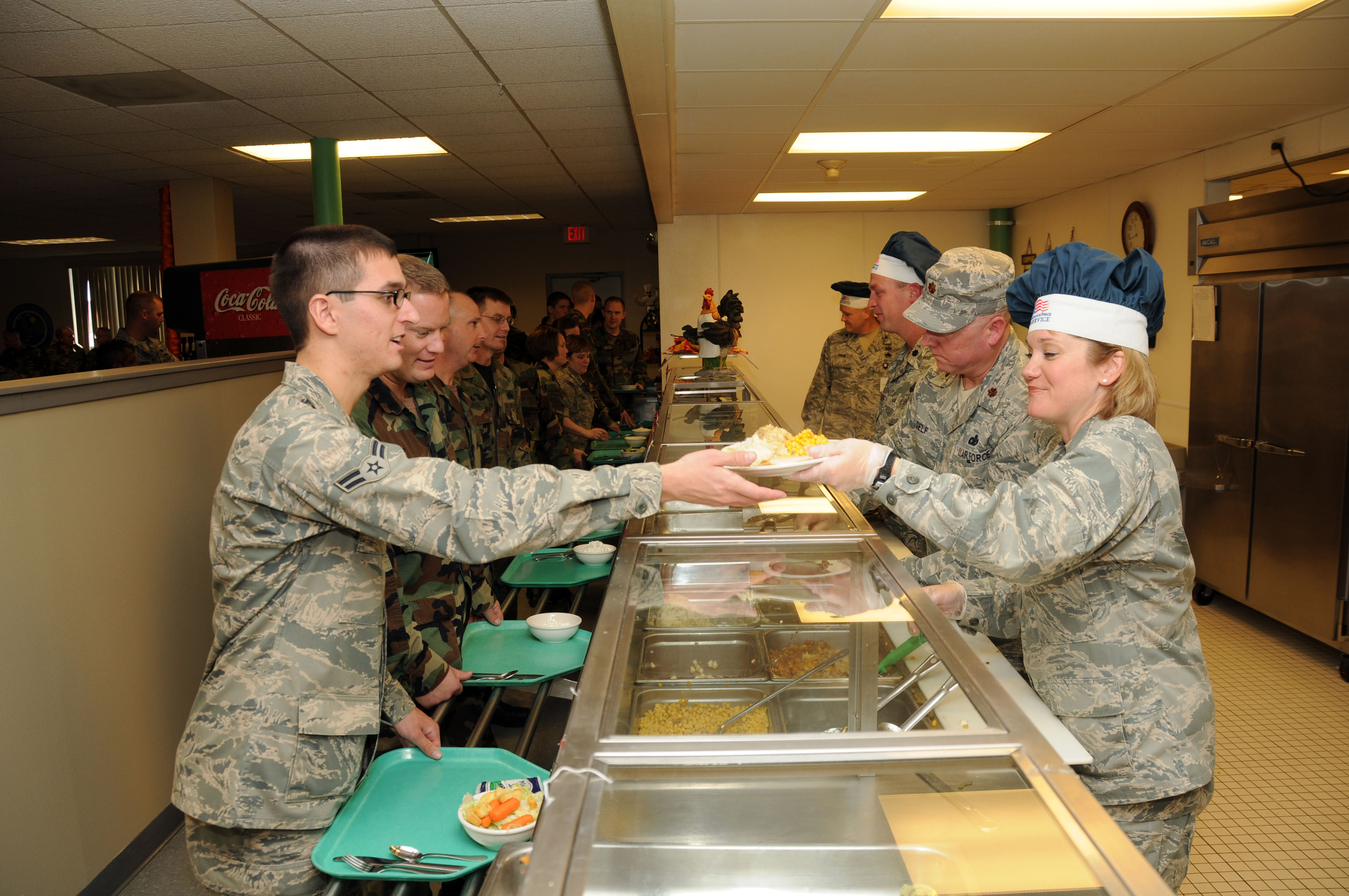 Officers serve dinner.
