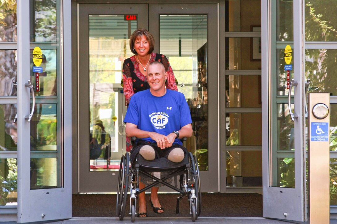 Army Lt. Col. Tim Karcher and his wife, Alesia, leave a physical ...