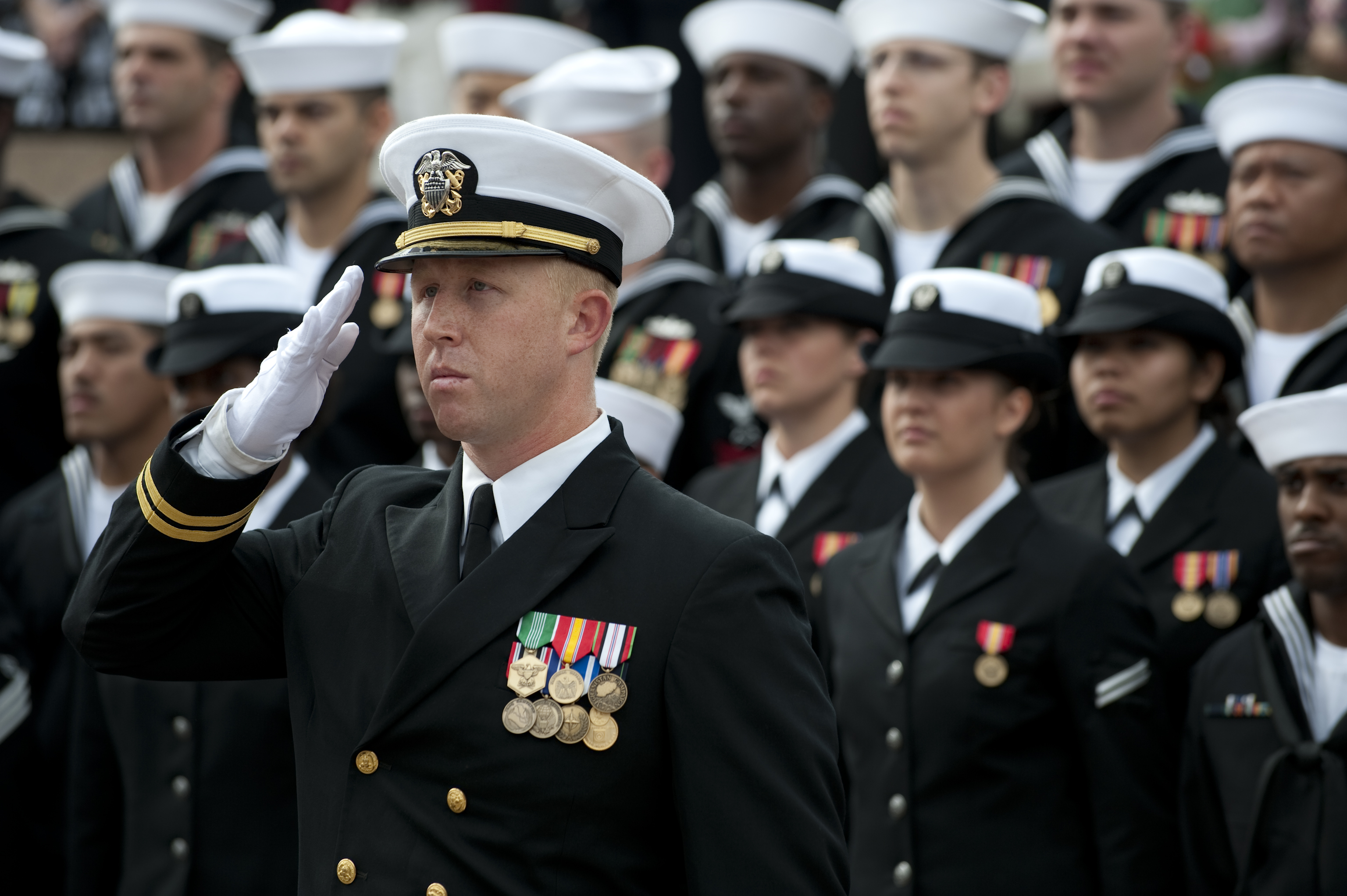 Crew members of the U.S. Navy's newest Arleigh Burke-class guided ...