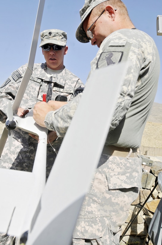 Army Staff Sgt. Tyrone Baird and Army Spc. Mitchell Matney assemble a ...