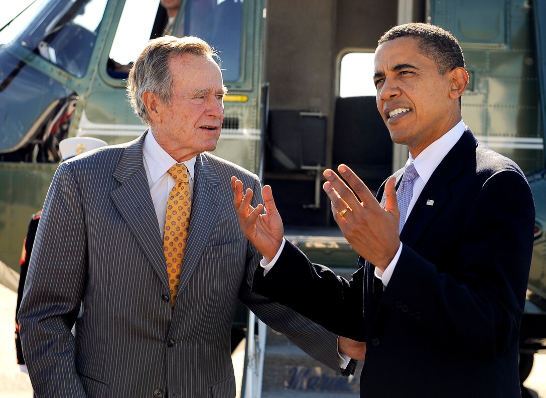 Former President George H.W. Bush, left, talks with President Barack Obama after arriving in ...