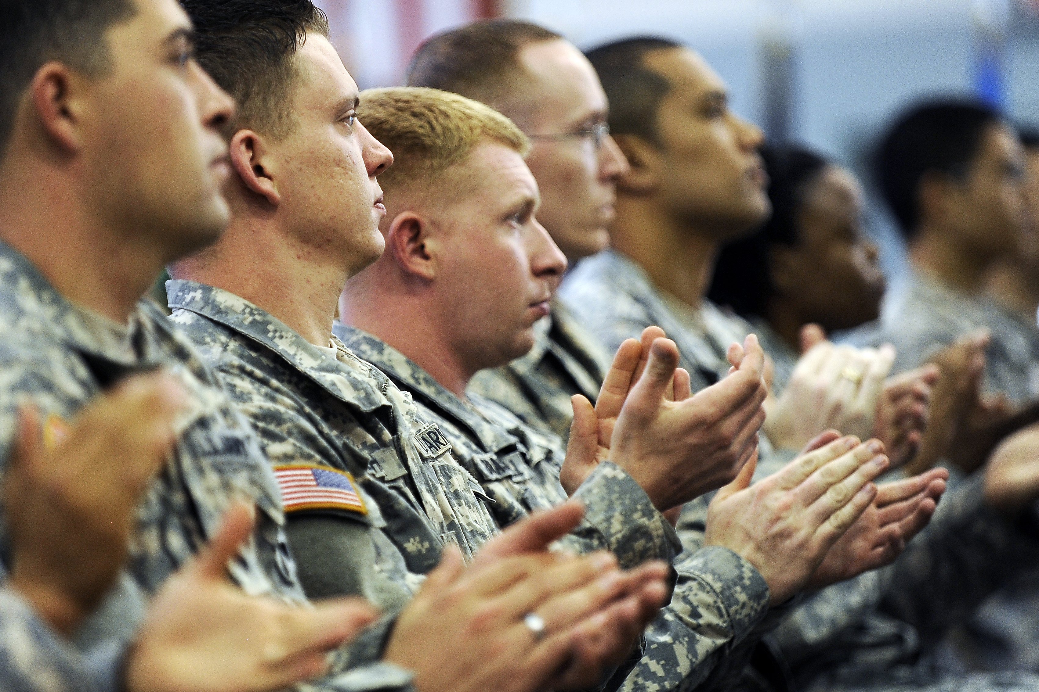 U.S. Army soldiers applaud as U.S. Defense Secretary Robert M. Gates is ...