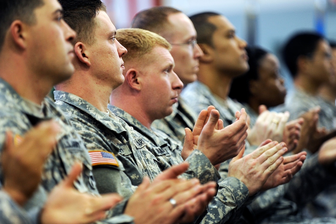 U.S. Army soldiers applaud as U.S. Defense Secretary Robert M. Gates is ...