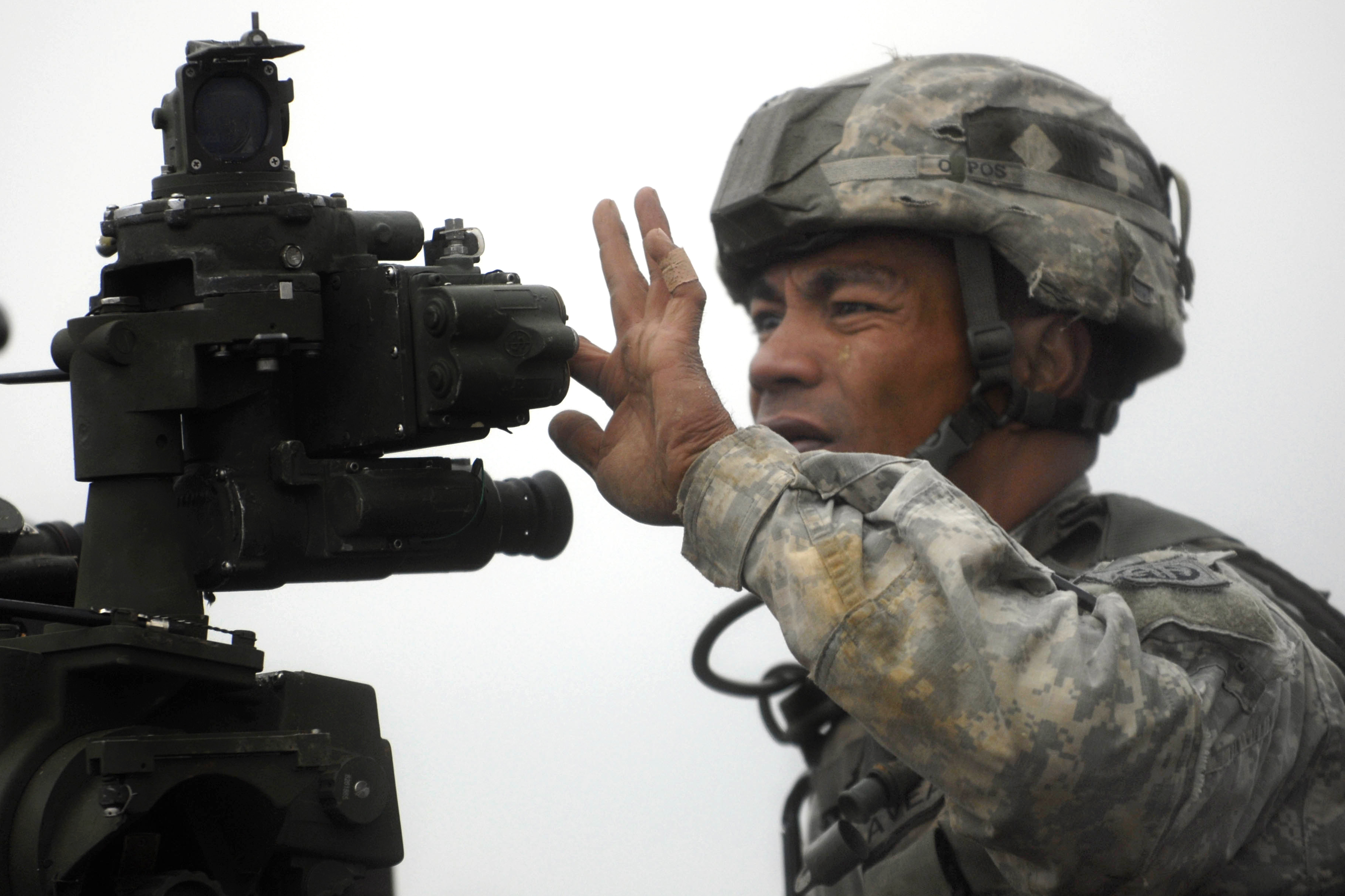 U.S. Army Sgt. Haseni Lave aims the howitzer to fire during a training ...