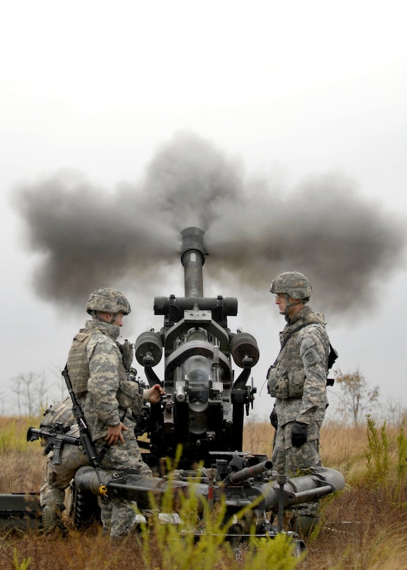 U.S. Army soldiers fire a howitzer during a training exercise on Fort ...