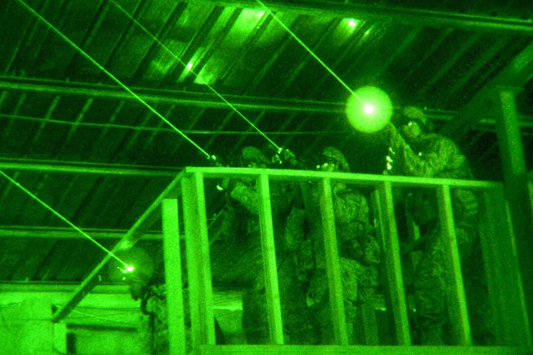 As seen through a night-vision device, U.S. Army paratroopers train ...