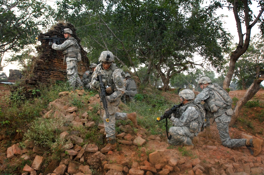 U.S. Army soldiers work to clear a village during a mock terrorist ...