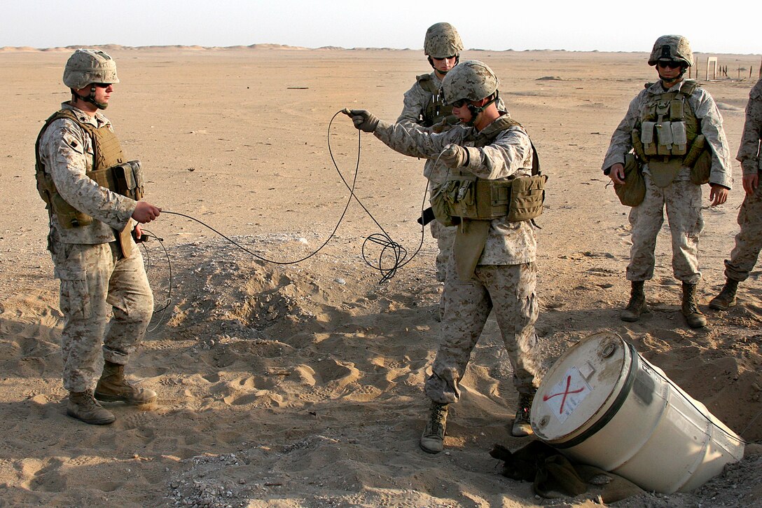 U.S. Marines measure a detonation cord for a 55-gallon improvised flame ...