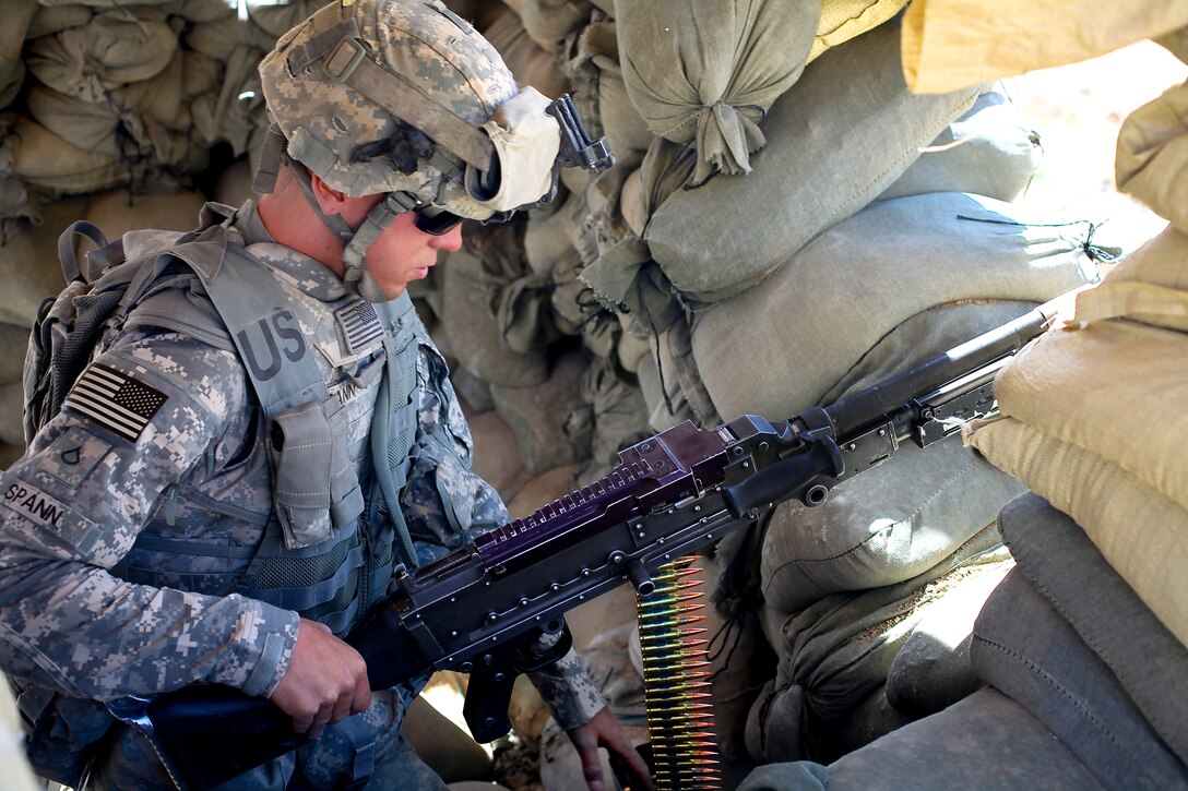 U.S. Army Joshua Spann loads a belt of 7.62mm Nato rounds into his ...