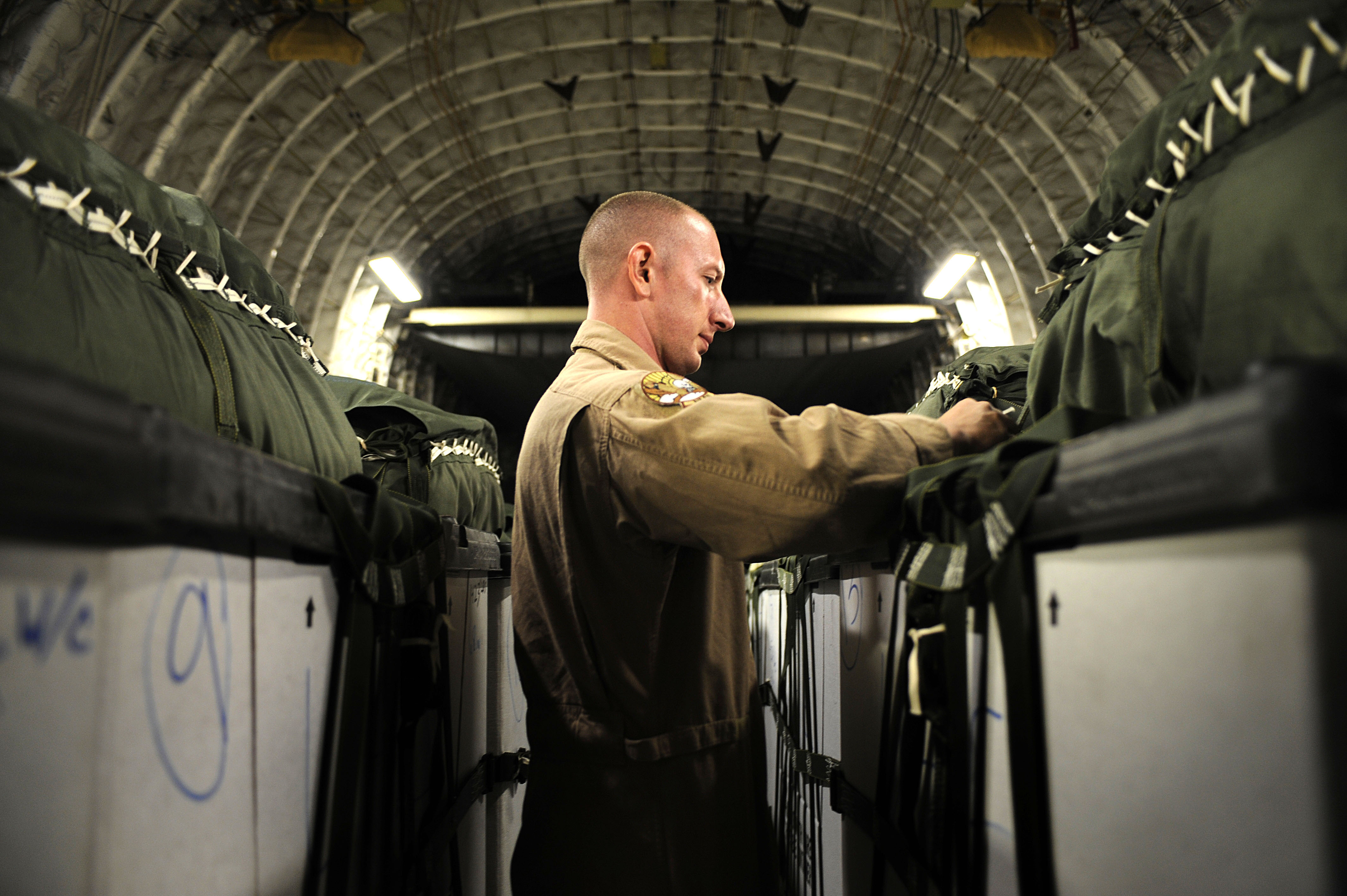 Loadmaster checks the rigging before an air drop