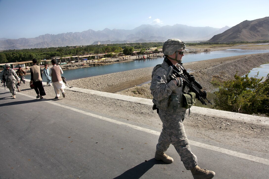 U.S. Army Cpl. Michael Tacker walks back to his vehicle after providing ...