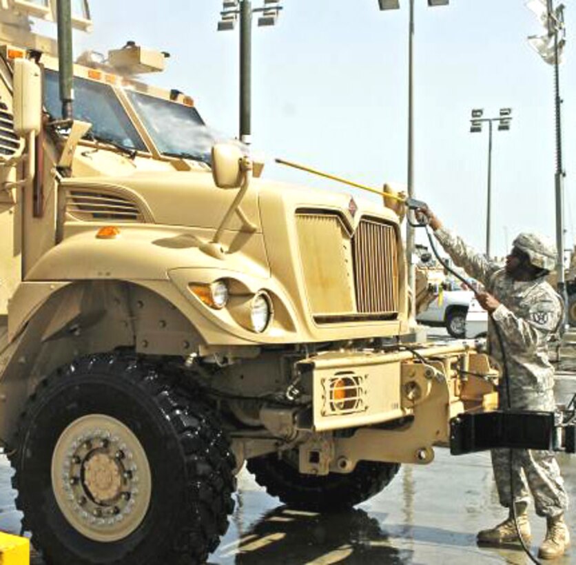 Army Spc. Anthony Simms sprays down a mine-resistant, ambush-protected ...