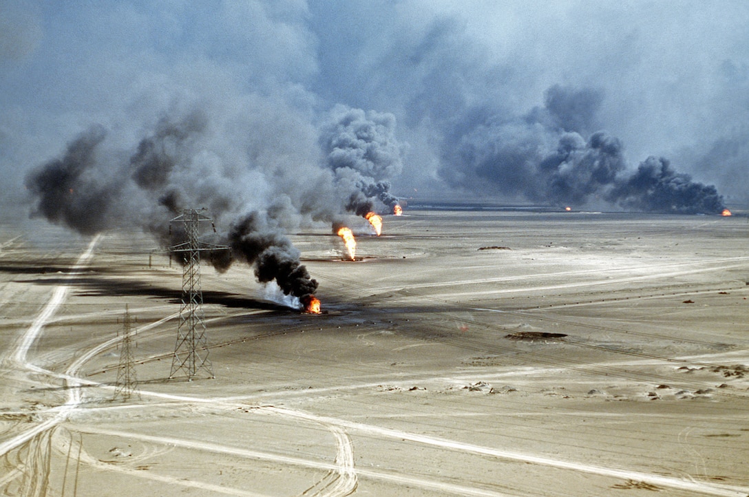 Oil wells burn out of control, darkening the sky with smoke, after ...