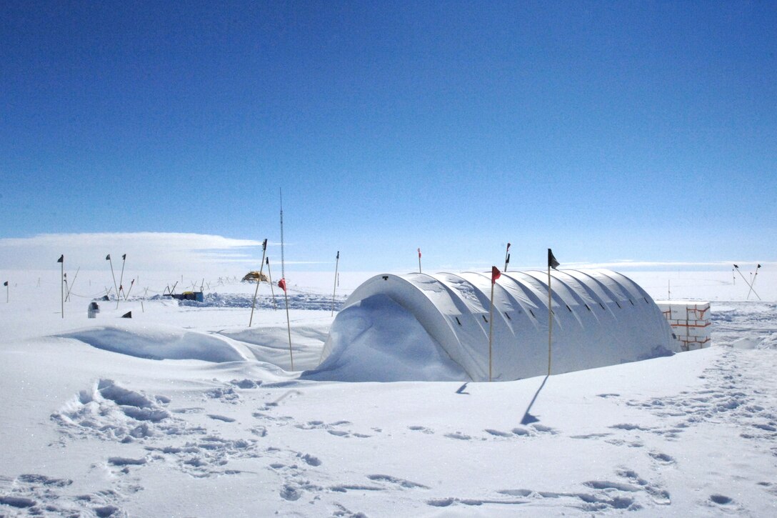 Ice core samples are stacked outside just above the site where they ...