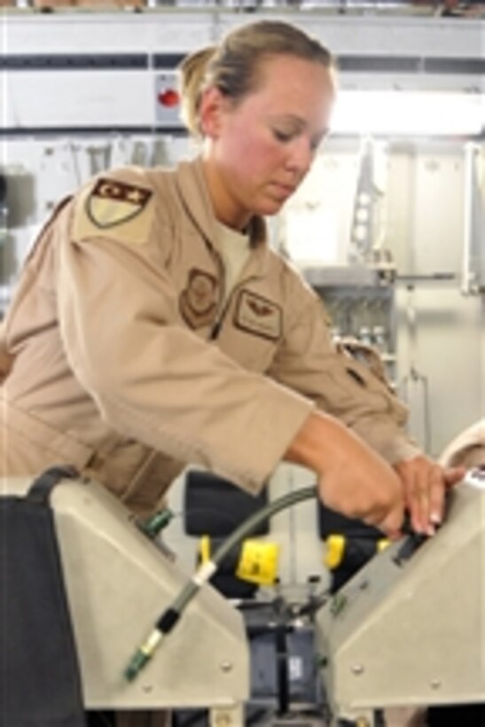 Tech. Sgt. Lindy Snodgrass connects the emergency oxygen system to a ...