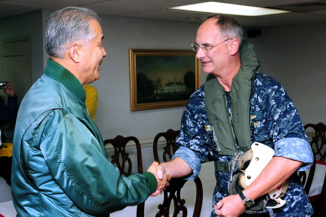 U.S. Navy Rear Adm. Richard Landolt, right, commander of the U.S. 7th ...