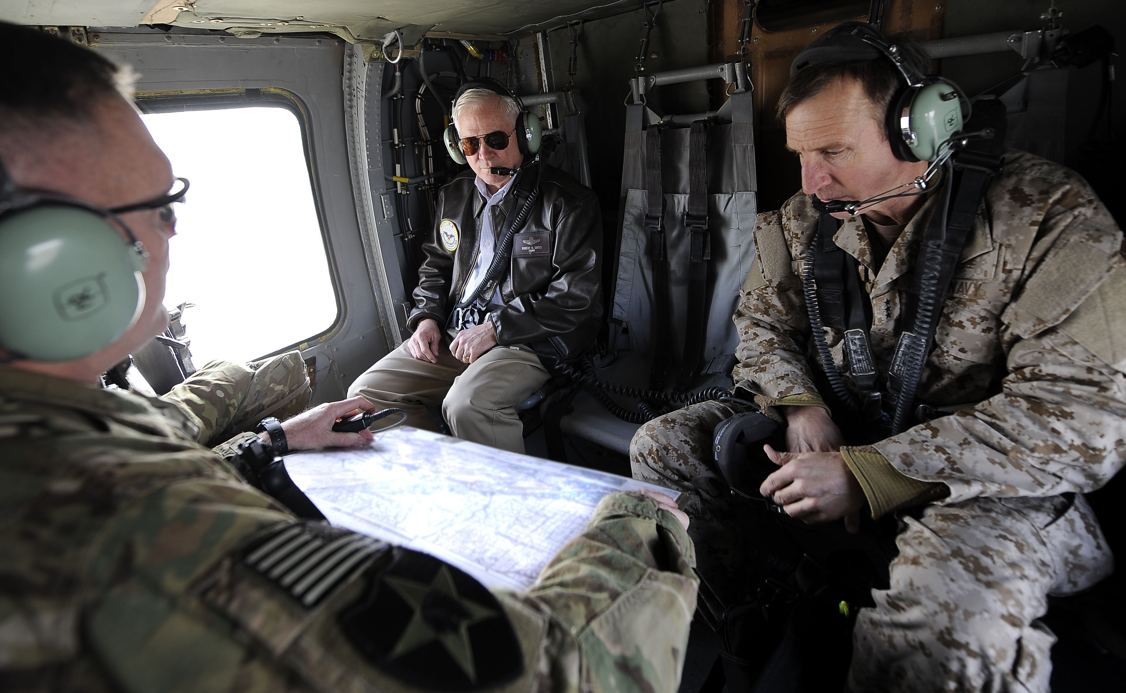 U.S. Defense Secretary Robert M. Gates, center, receives a briefing ...