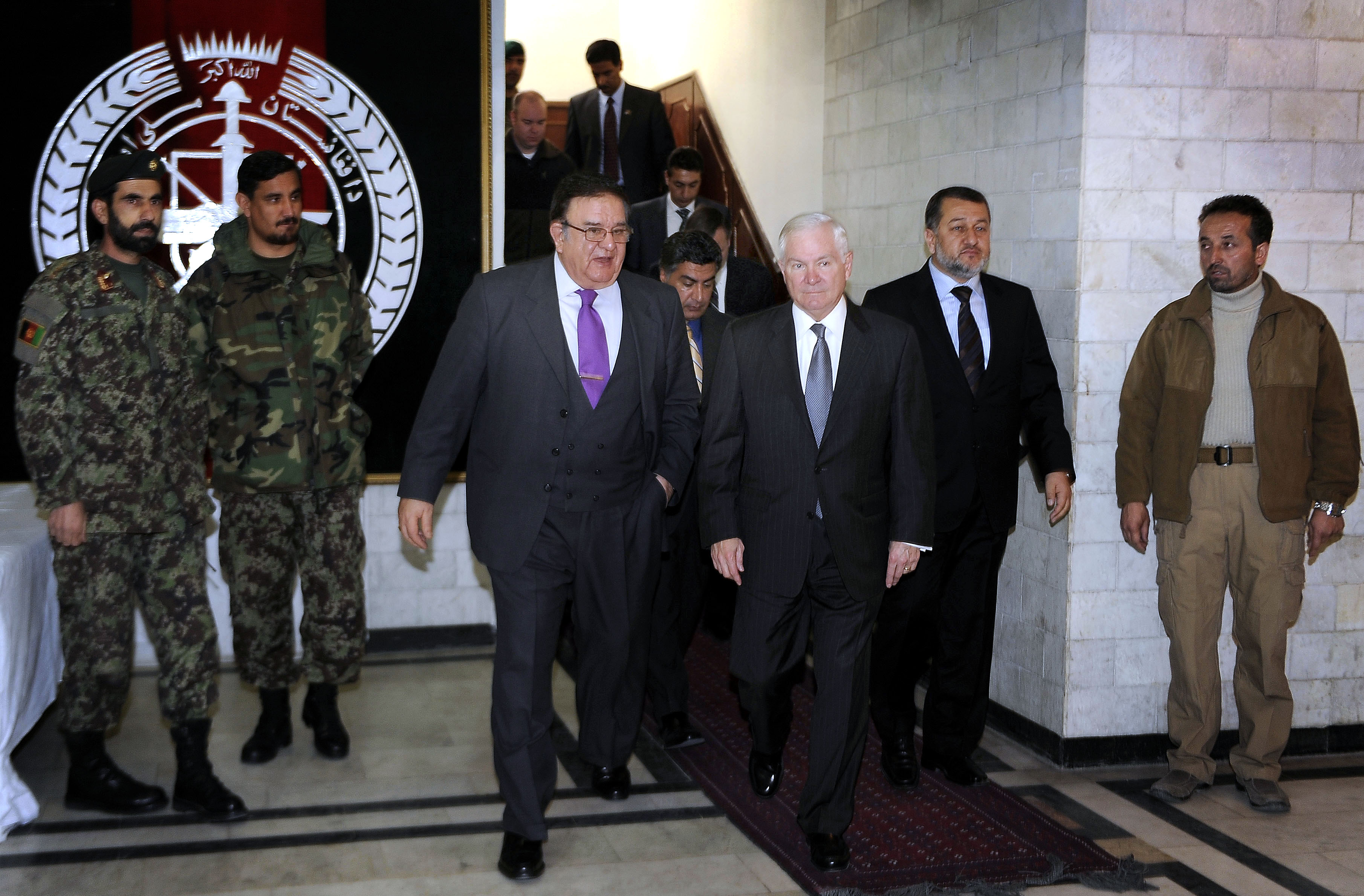 U.S. Defense Secretary Robert M. Gates, center-right, walks with ...