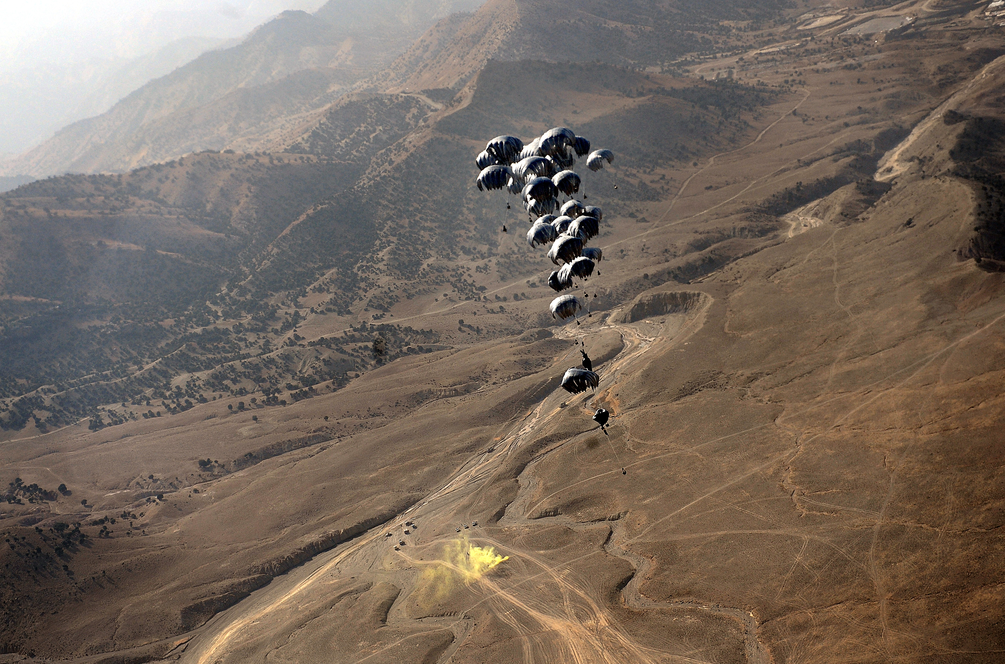 Bundles of fuel and supplies are air dropped from a U.S. Air Force ...
