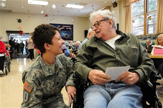 Staff Sgt. Amy Wieser Willson visits with a resident of the North ...