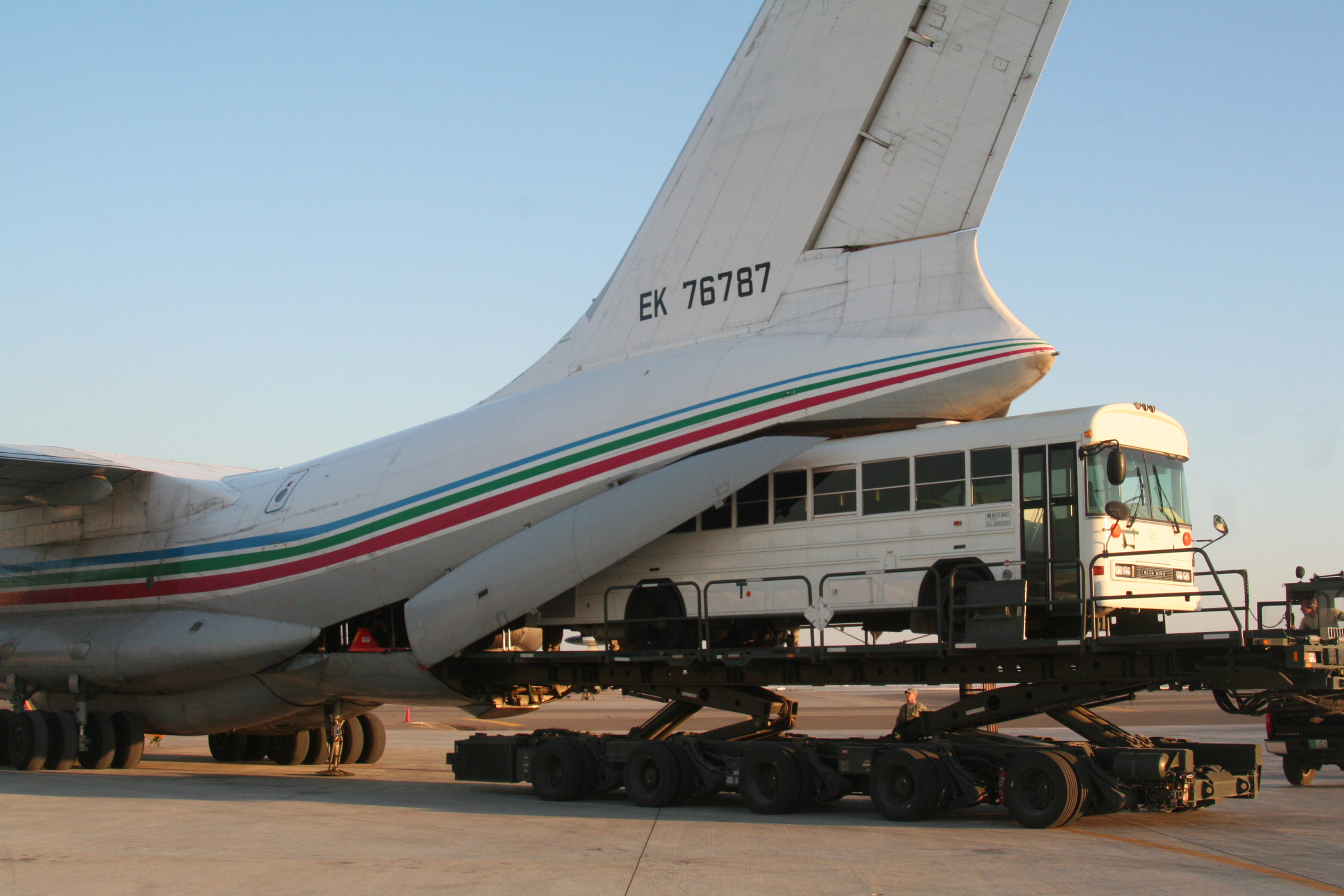 Deployed aerial porters load American buses on Russian-made transport