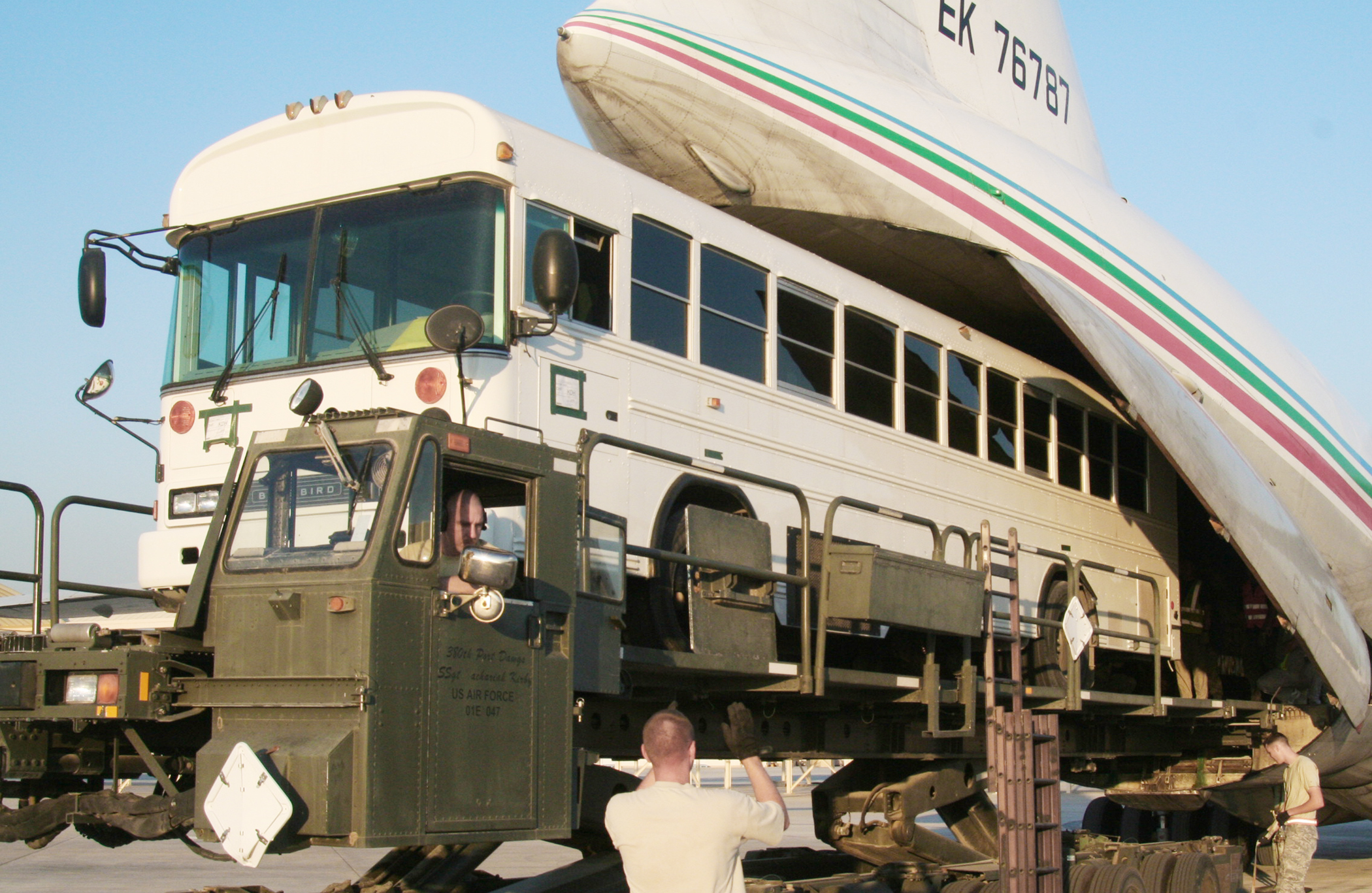 Deployed aerial porters load American buses on Russian-made transport