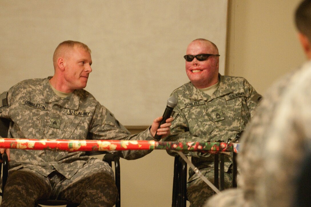 Retired Army Sgt. Bill Congleton holds a microphone for Army Sgt. 1st ...