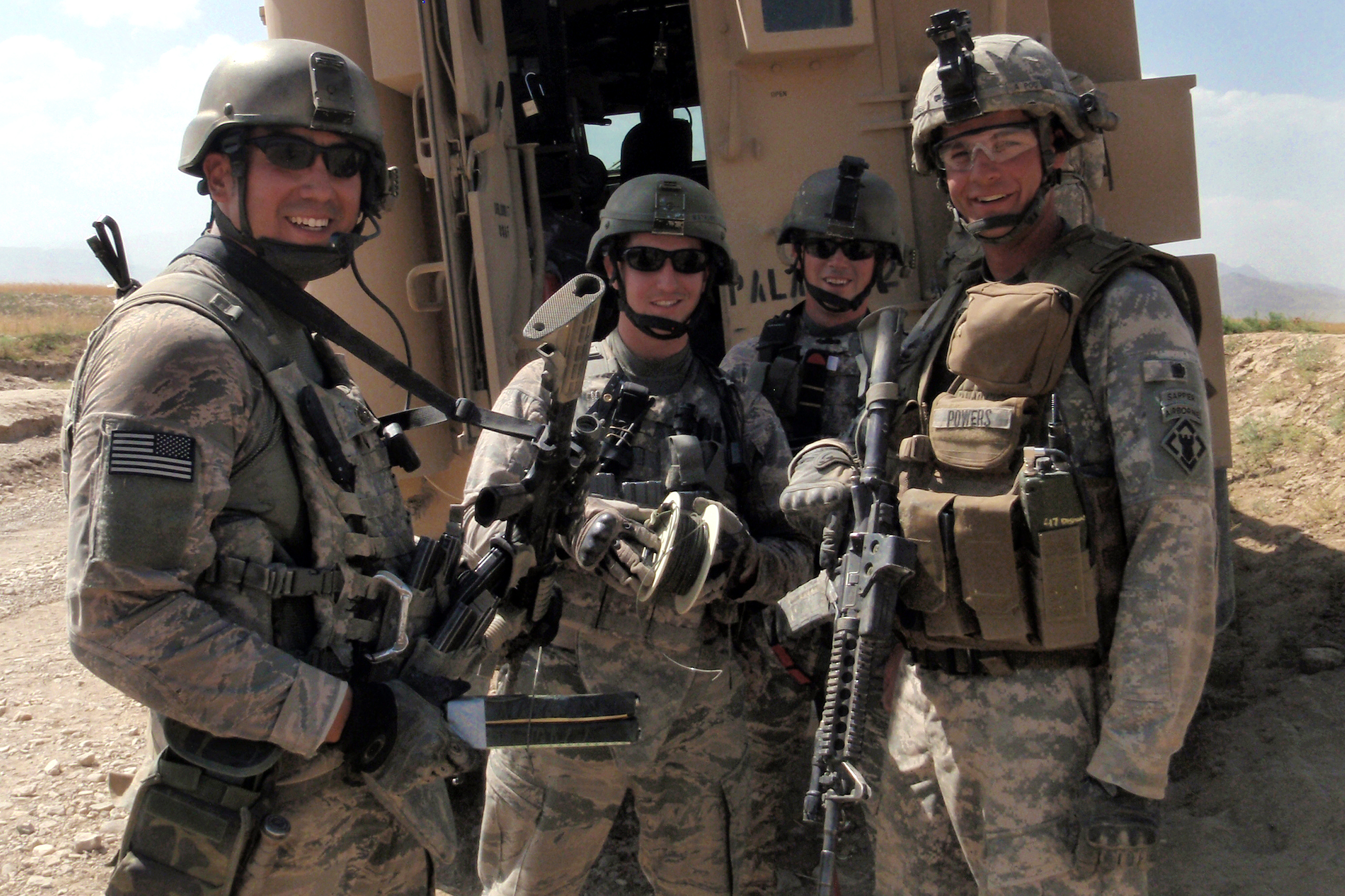 U.S. soldiers and airmen pose after finding a road bomb south of Babus ...