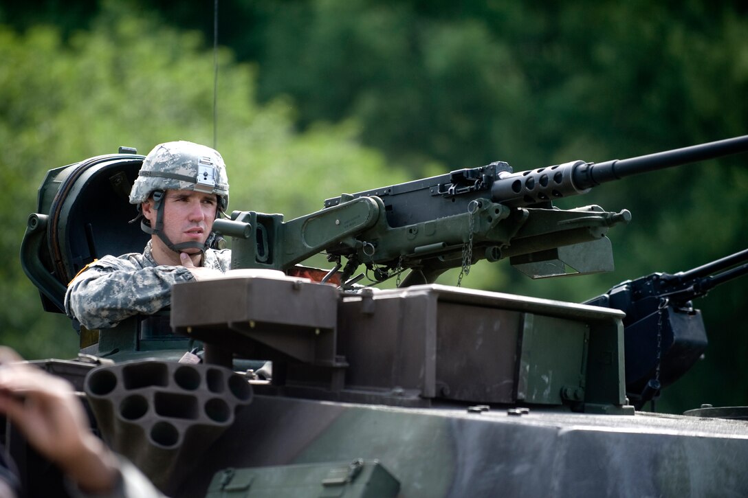 A U.S. Army soldier from the 1st Heavy Brigade Combat Team listens as U ...