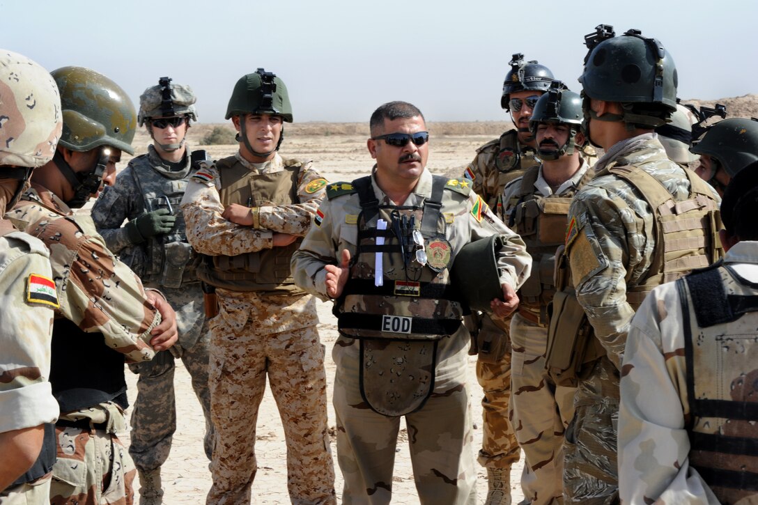 Iraqi soldiers receive a briefing on explosive ordnance disposal, which ...